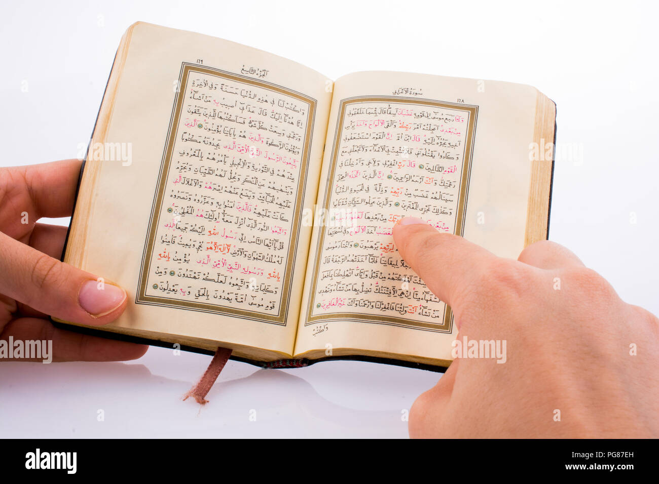 Hand holding The Holy Quran on a white background Stock Photo - Alamy