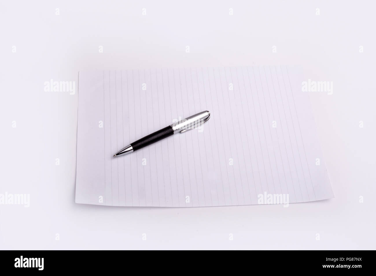 Pen and plain color paper on an isolated background Stock Photo - Alamy