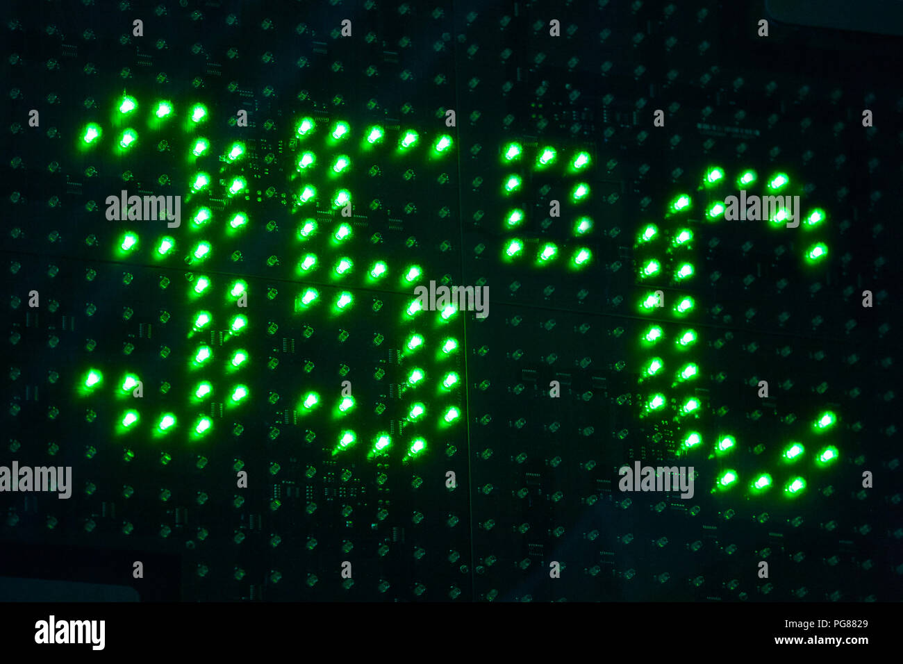 Outdoor thermomether display with green lights. Hot summer. 35 Celsius ...