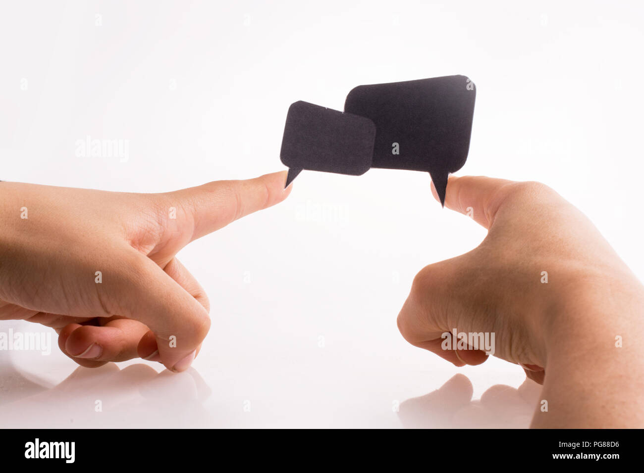 Hand holding dialogue boxes on a white background Stock Photo - Alamy