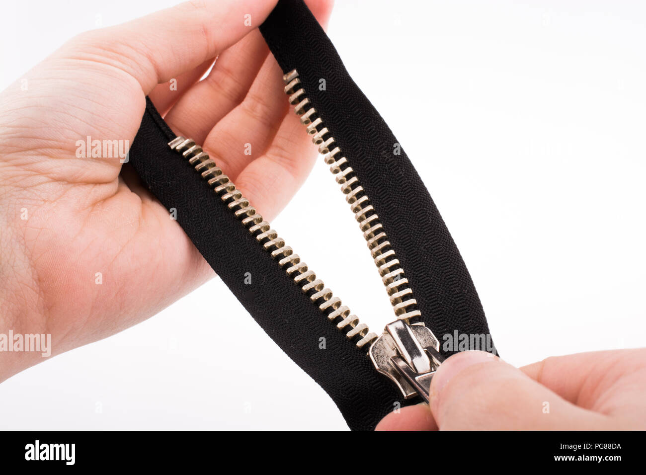 Hand holding color zipper on a white background Stock Photo - Alamy