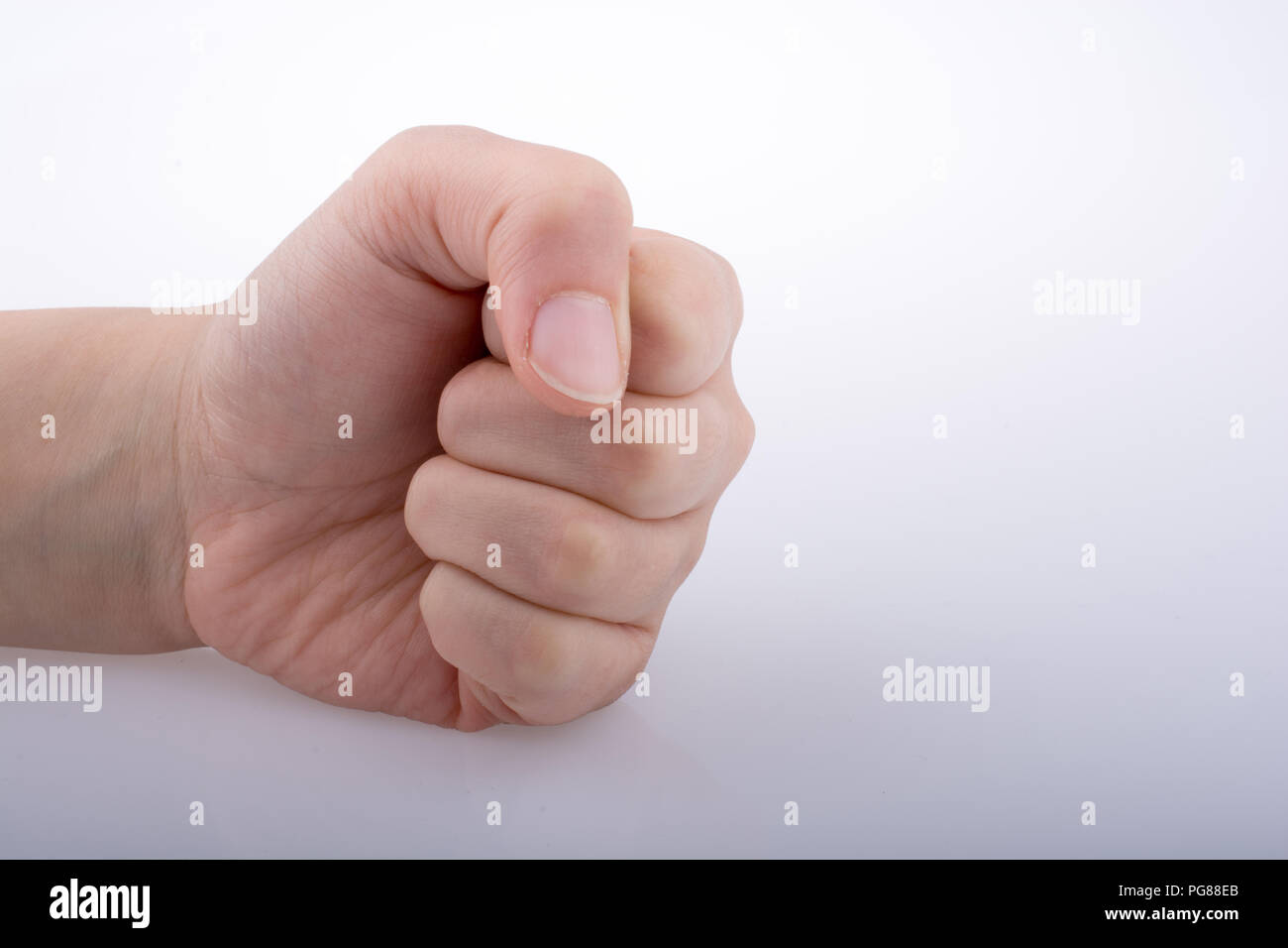 Clenched fist on a white background Stock Photo - Alamy