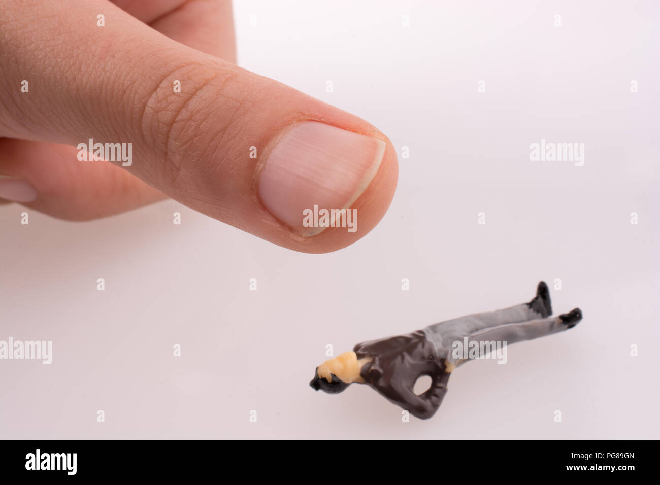 Hand threating to smash human figure on a white background Stock Photo ...