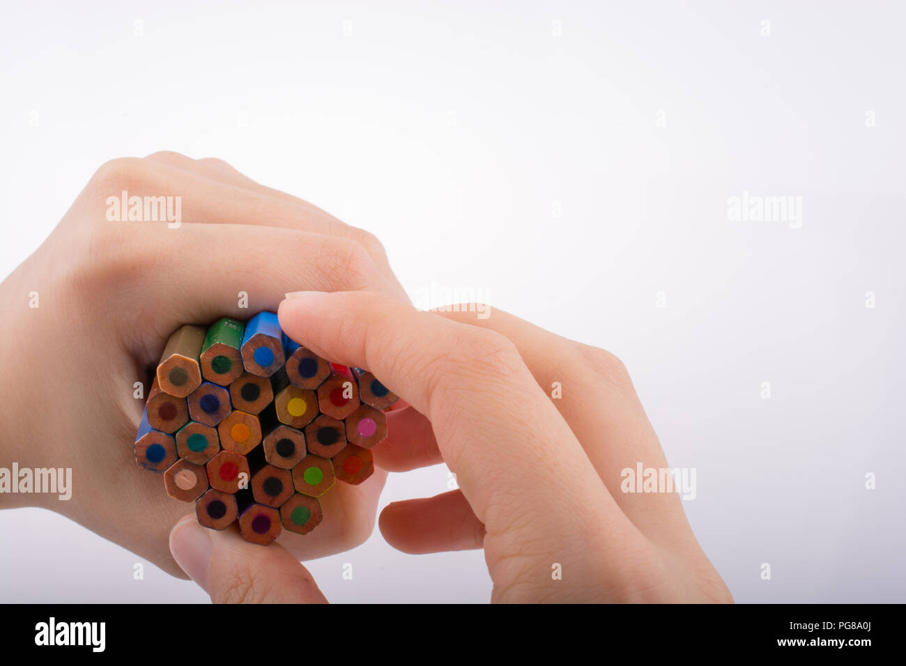 Hand holding color pencils on a white background Stock Photo - Alamy