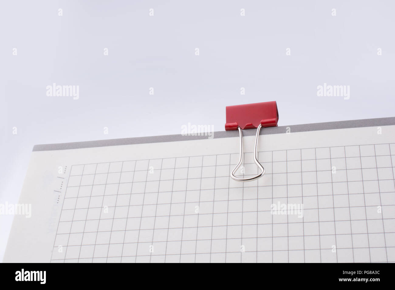 Clip on a checked notebook Stock Photo - Alamy