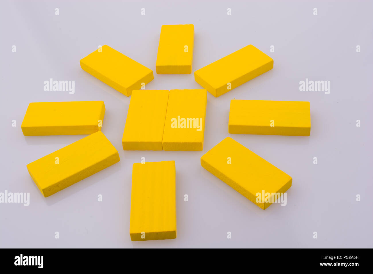 Color Dominoes making a sun on a white background Stock Photo - Alamy