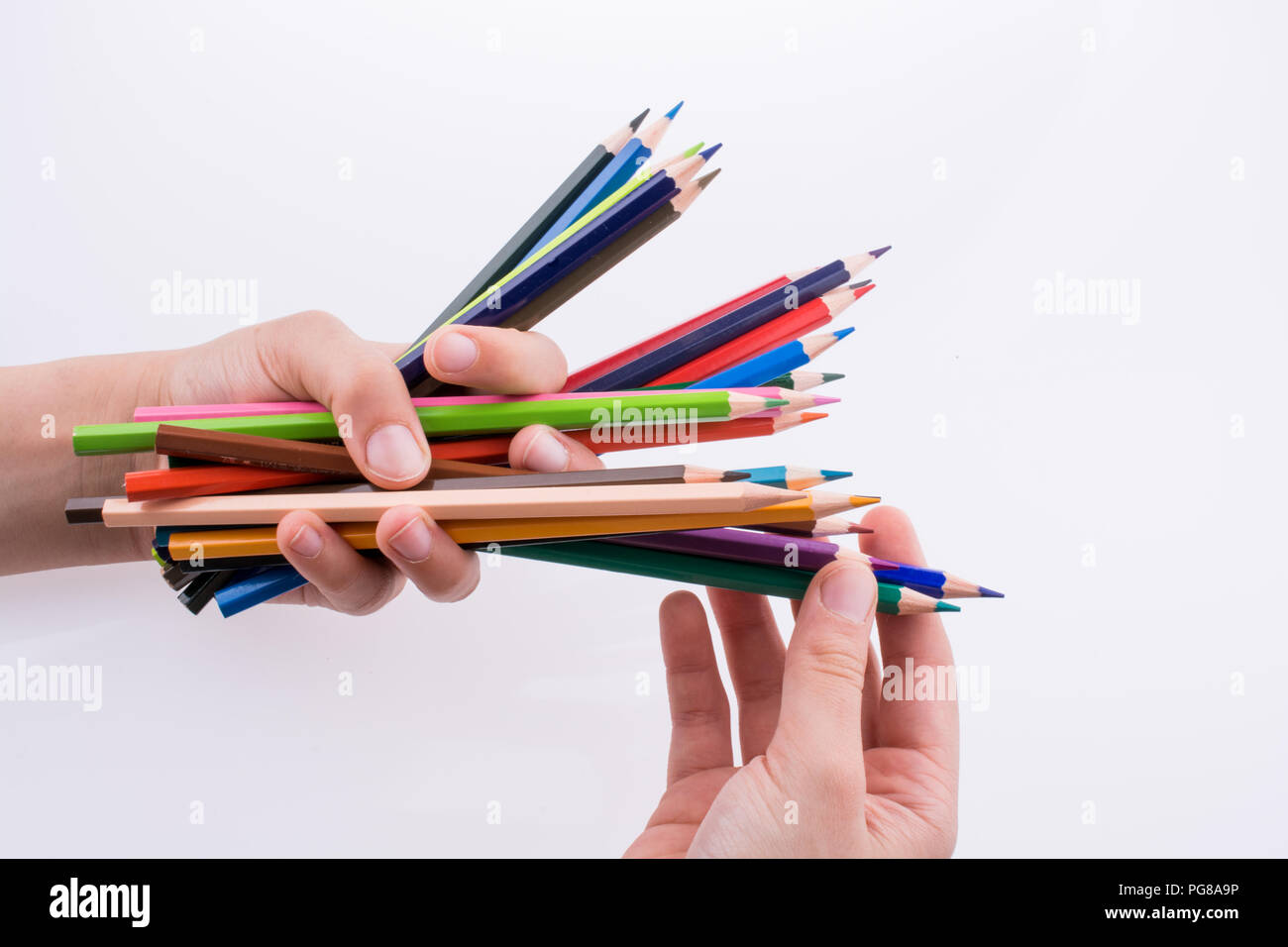 Hand holding color pencils on a white background Stock Photo - Alamy