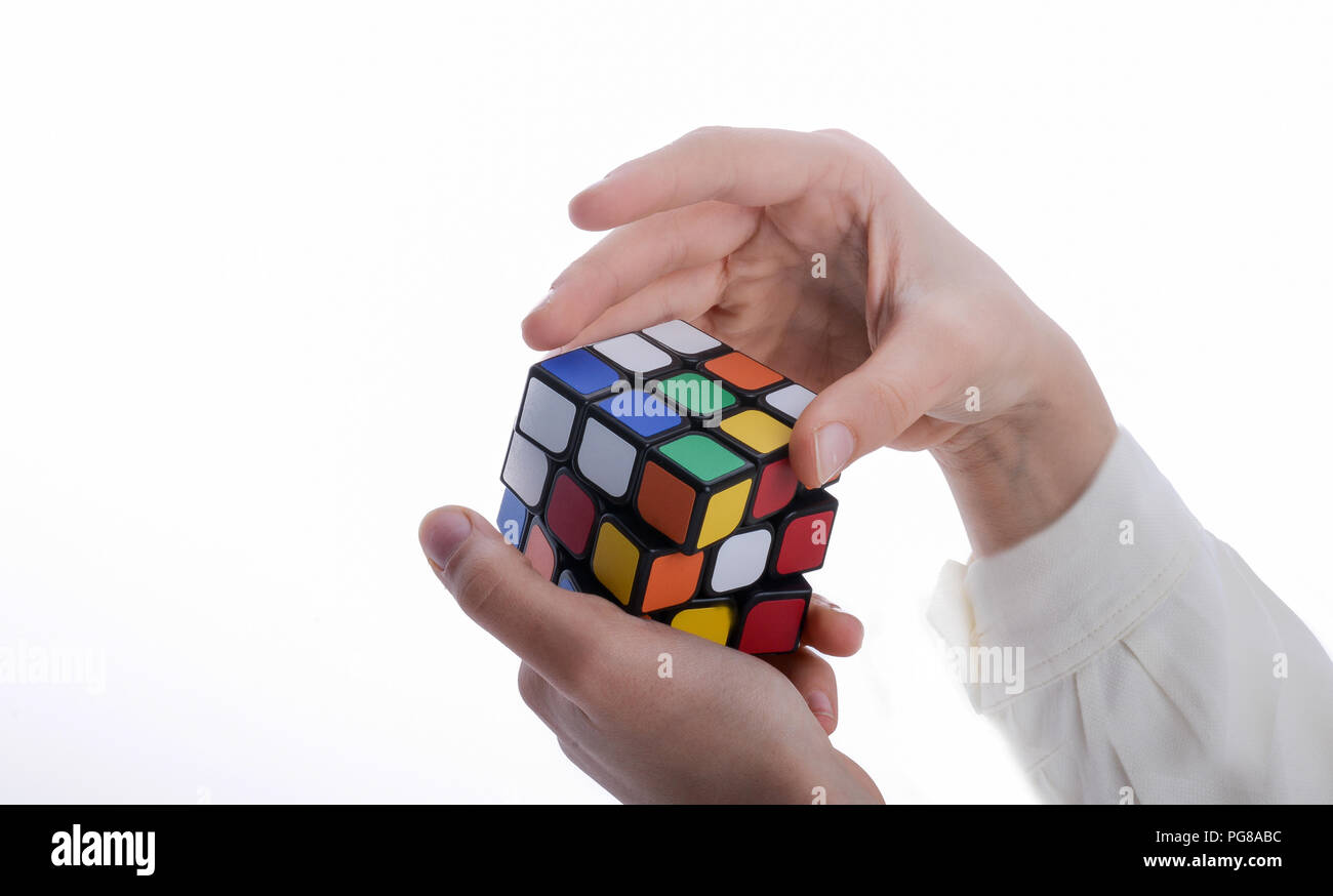 Child holding a Rubik's cube in hand on a white background Stock Photo ...