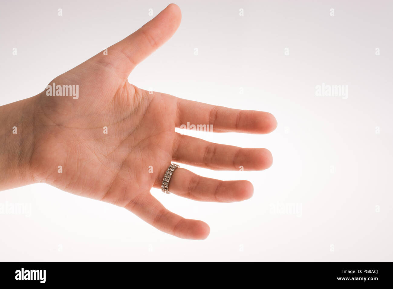 Hand wearing a ring on a white background Stock Photo - Alamy