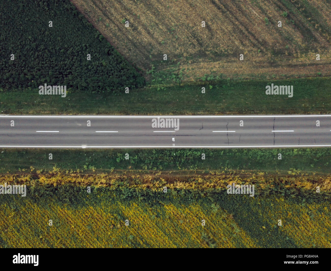 Drone photography of empty road through plain countryside landscape ...