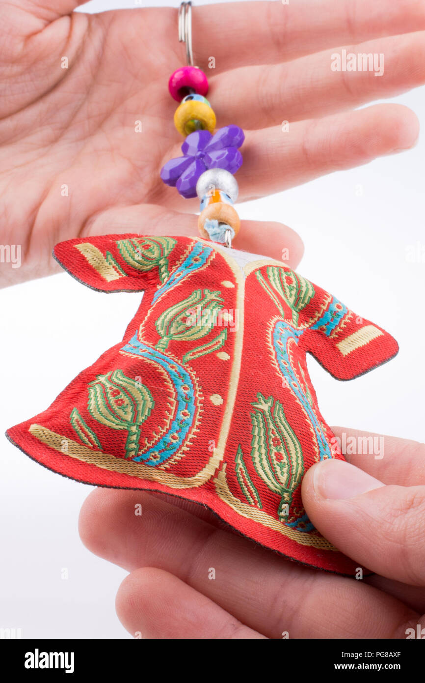 Hand holding traditional clothes with ornaments Stock Photo - Alamy