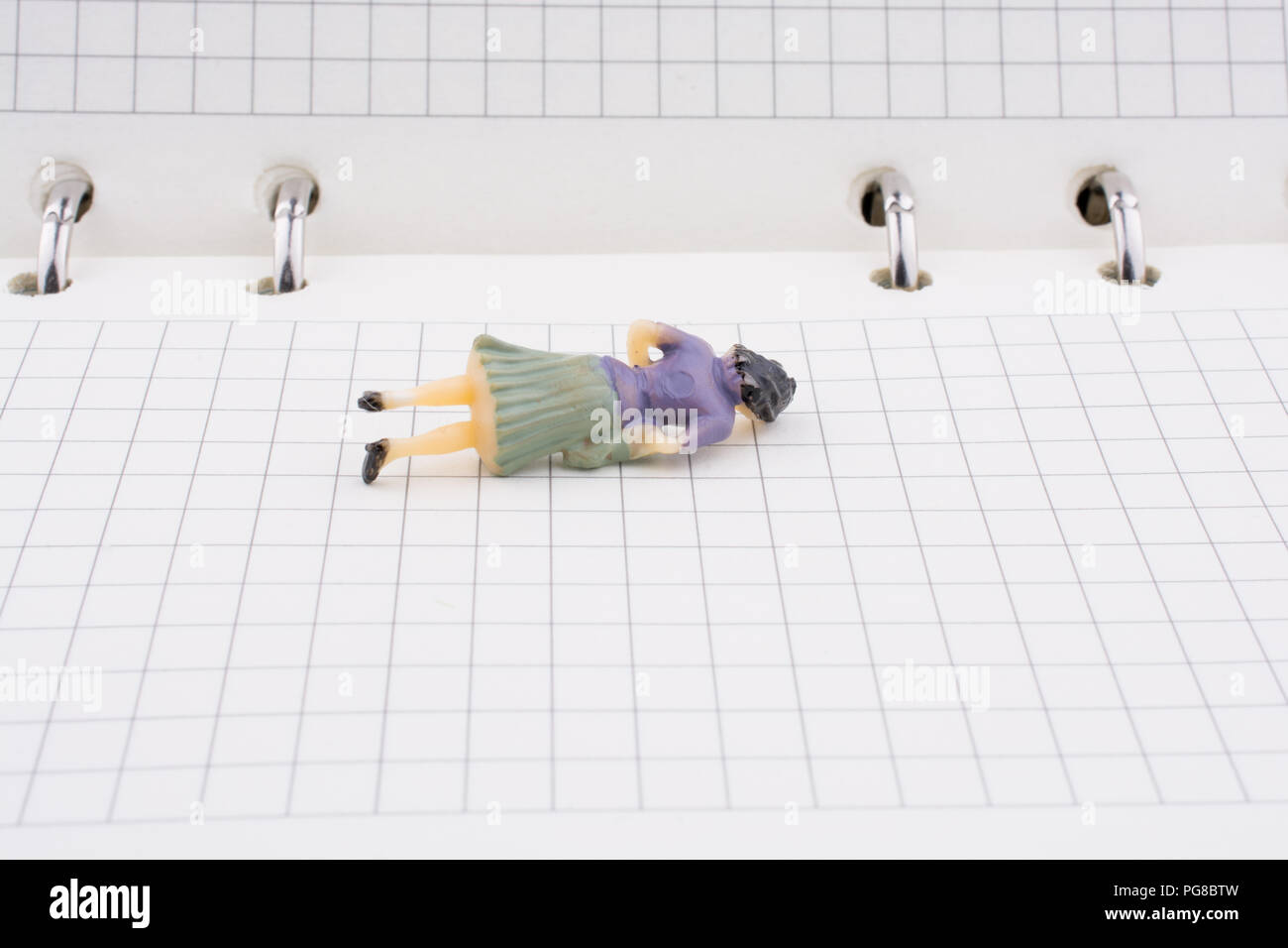 Human figure on a white spiral notebook Stock Photo - Alamy