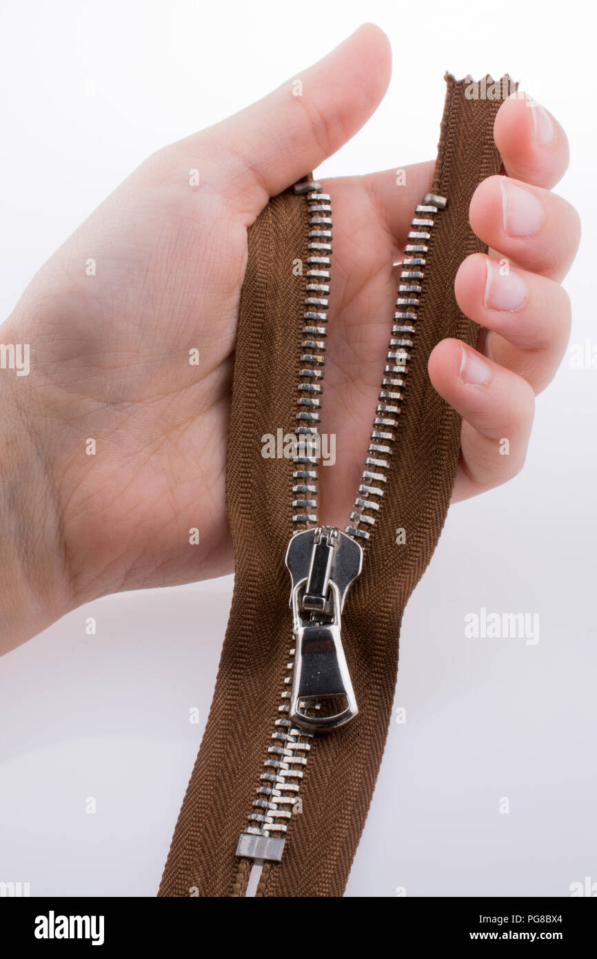 Hand holding color zipper on a white background Stock Photo - Alamy