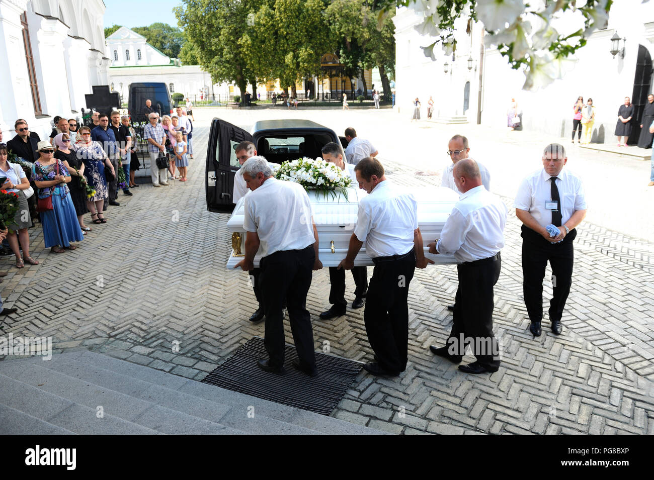 Funeral home workers carrying a coffin with a late inside for burial ...