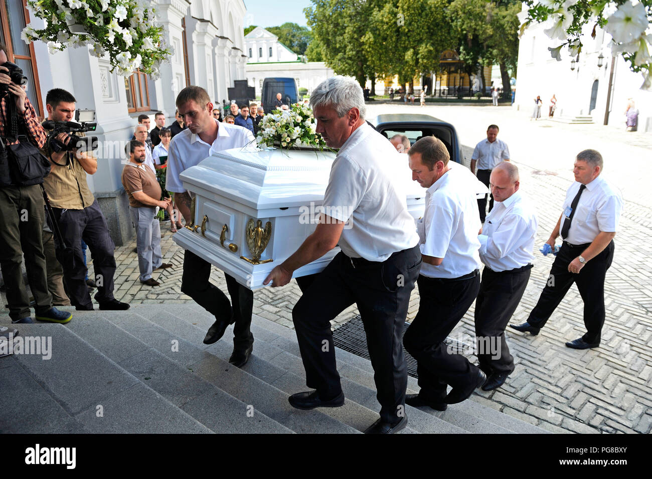 Funeral home workers carrying a coffin with a late inside for burial ...