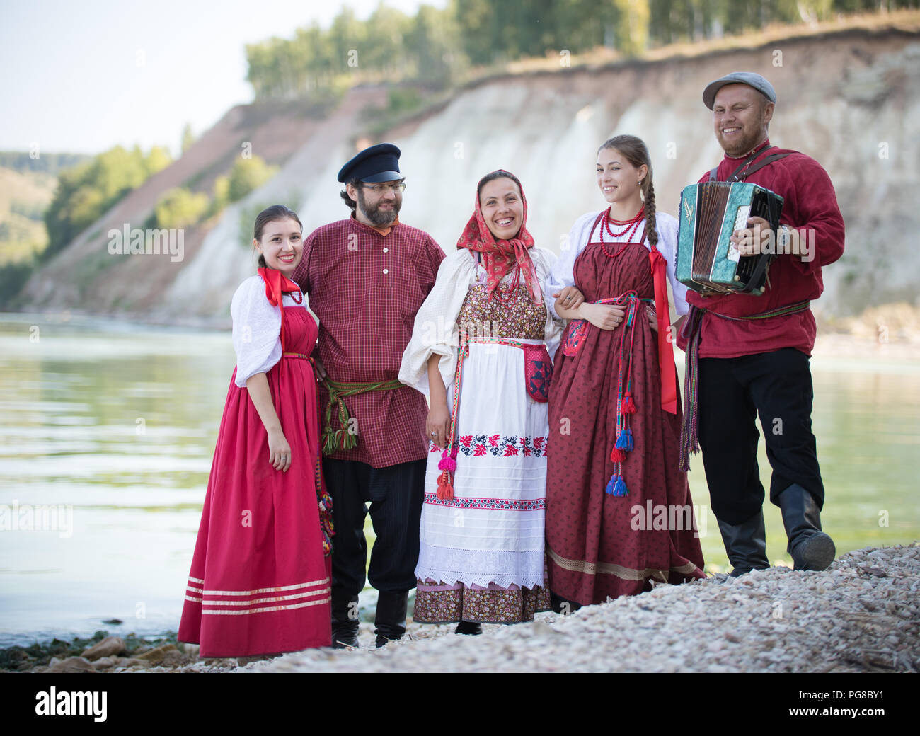 A group of beautiful people in the national Russian costume standing on ...