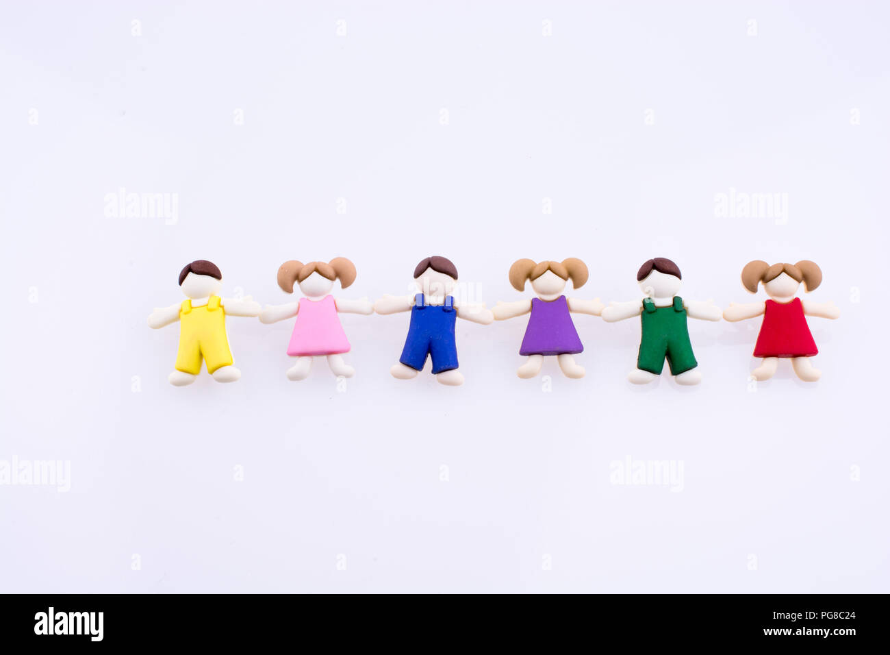 Colorful dressed children figures on a white background Stock Photo - Alamy