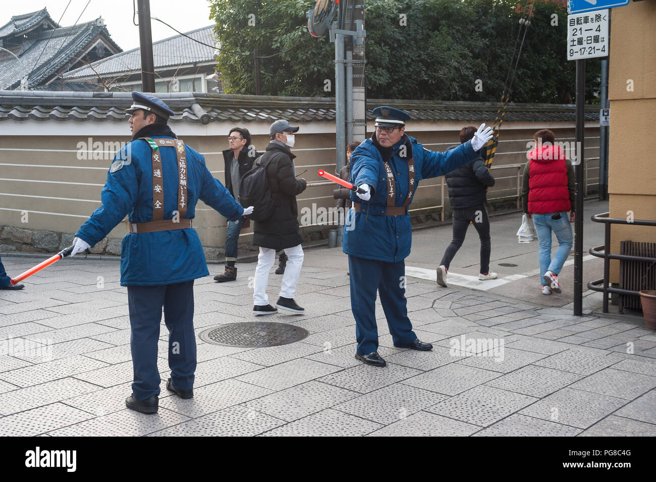 23.12.2017, Kyoto, Japan, Asia - Traffic wardens are seen regulating ...