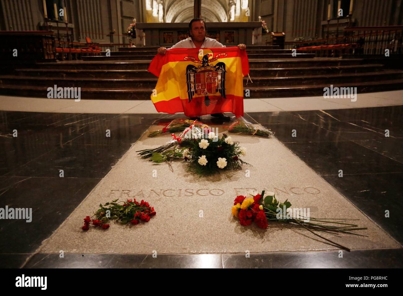 A man with the predemocratic flag in the tomb of dictator Franco in ...