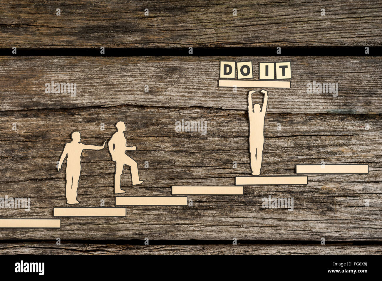 Do It concept with paper cutouts of men with one supporting the text as ...
