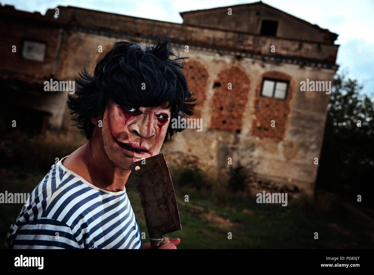 a scary disfigured man wielding a rusty and bloody cleaver in front of ...