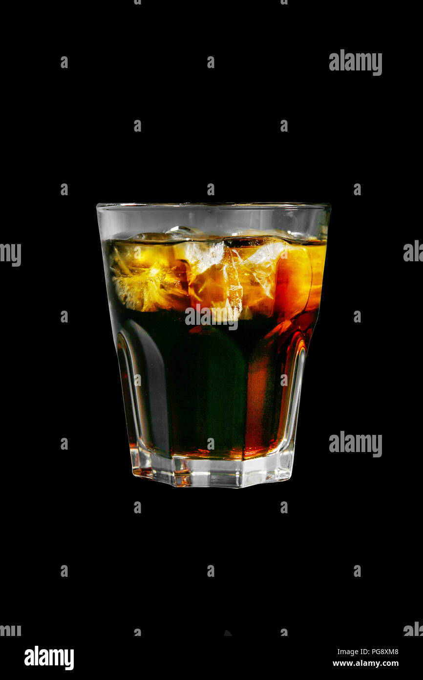 A single-colored transparent cocktail, refreshing in a low glass with ...