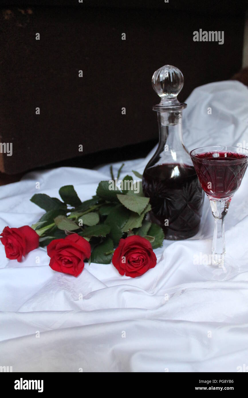 bouquet of red roses and aroma red wine in crystal glass for nice gift ...