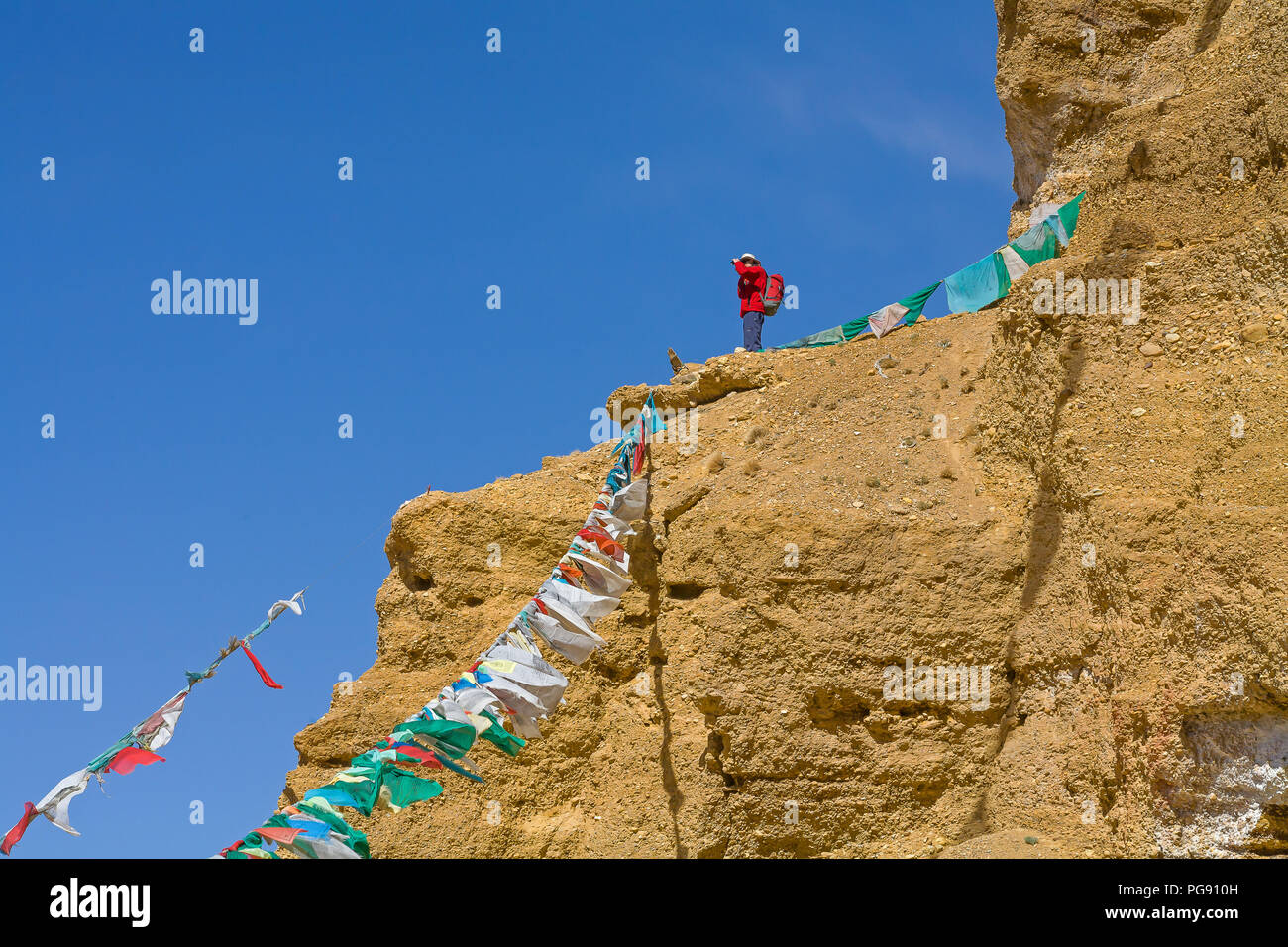 Tourist photographing the Guru Gyem Gompa, on the Sutlej, one of the ...