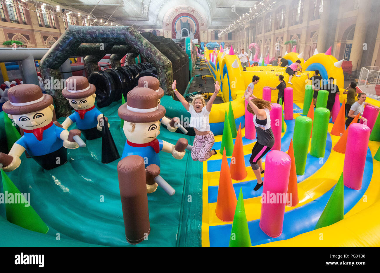 People tackle The Monster, a 300 metre long inflatable obstacle course ...