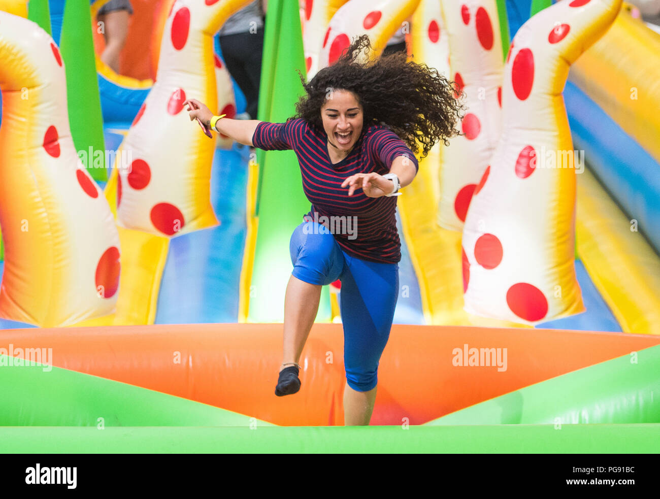 A woman tackles The Monster, a 300 metre long inflatable obstacle ...