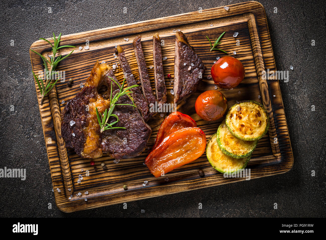 Grilled beef steak with vegetables top view Stock Photo - Alamy