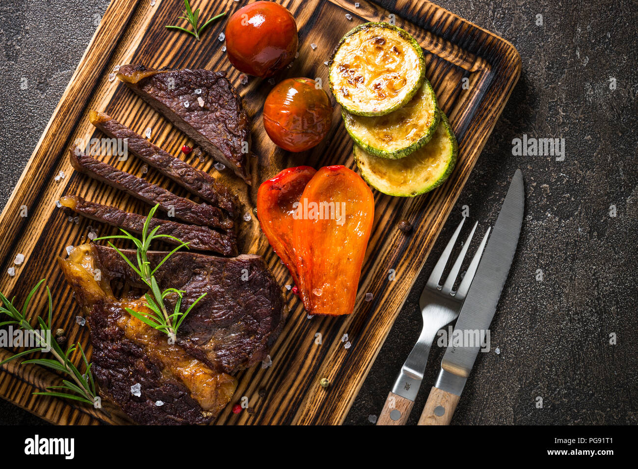 Grilled beef steak with vegetables top view Stock Photo - Alamy