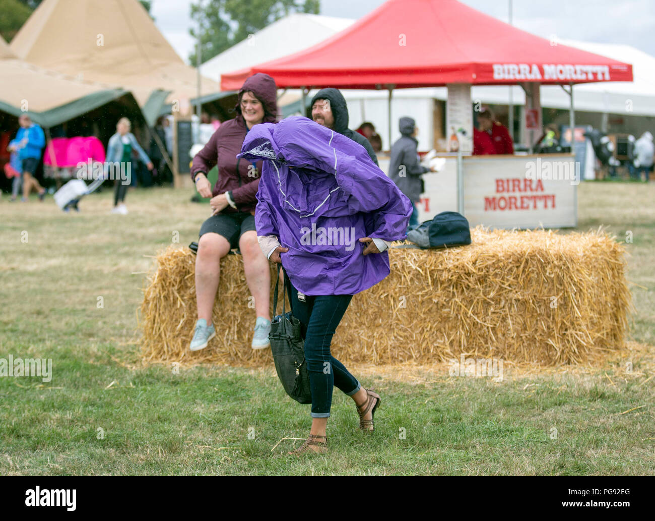 Festival goers face a rain shower during the Big Feastival at Alex ...