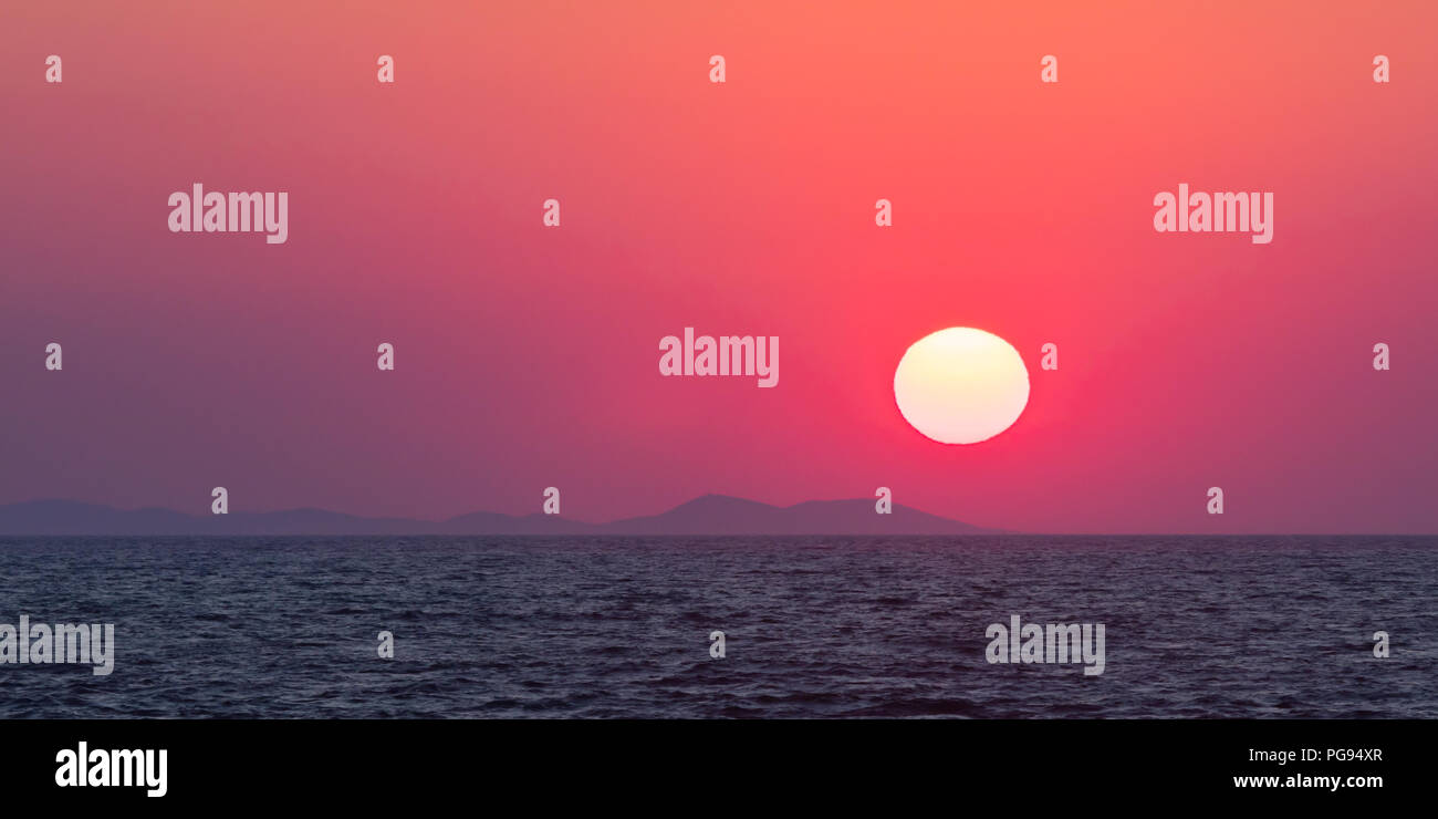 Large zoomed in sun about to set beyond the horizon as seen from Zadar ...