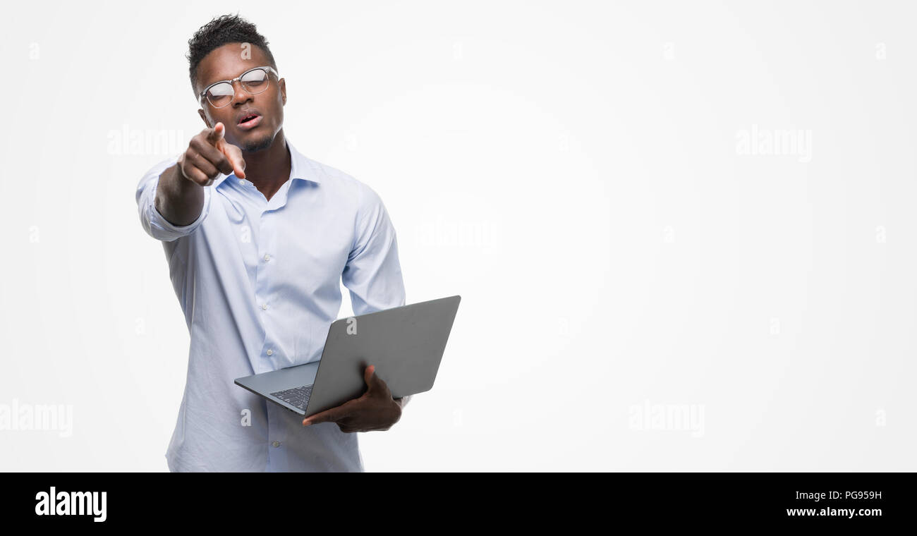 Young african american businessman using computer laptop pointing with ...