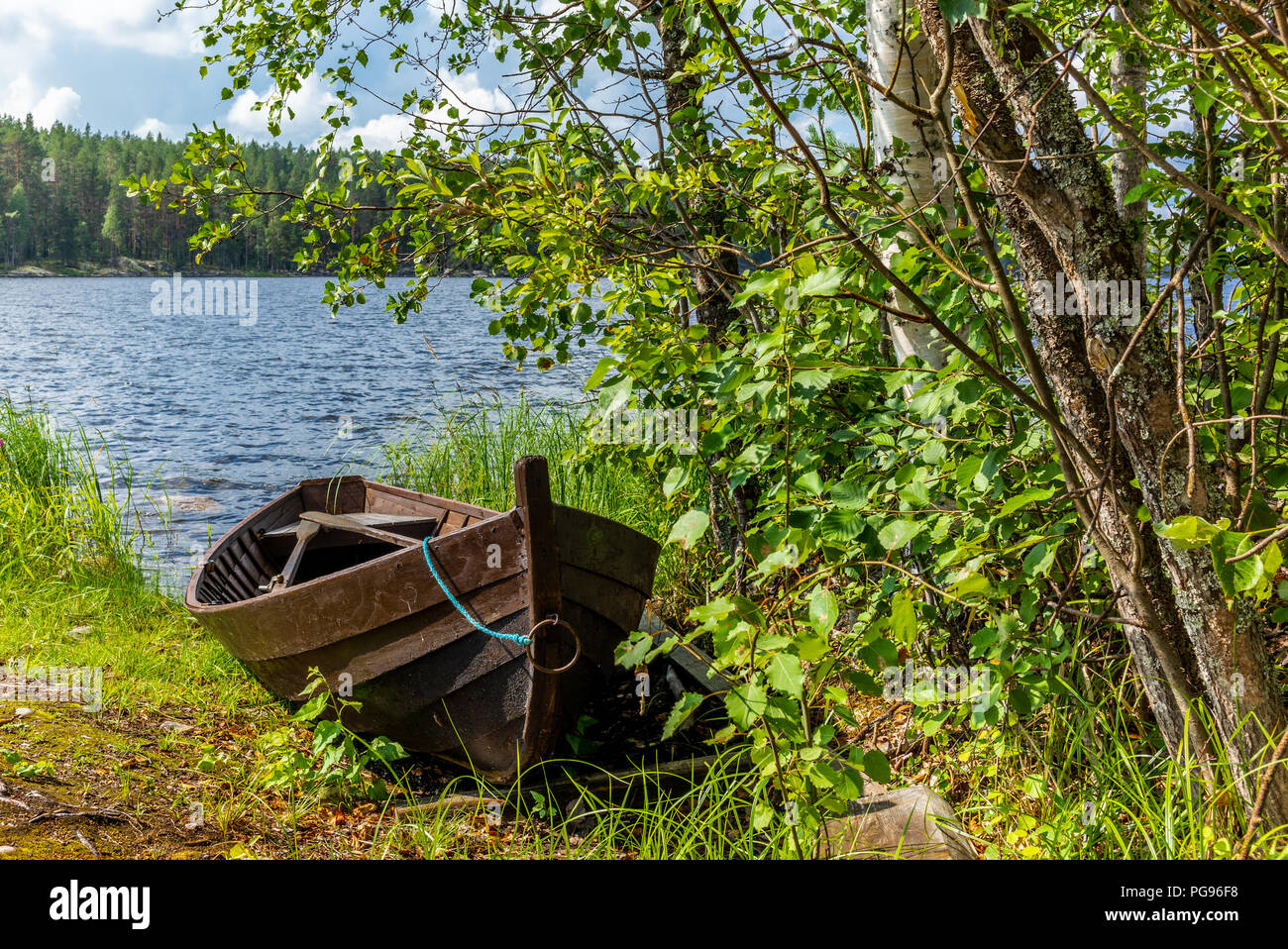 Old wooden rowing boat on the shore of the Saimaa lake in Finland - 1 ...