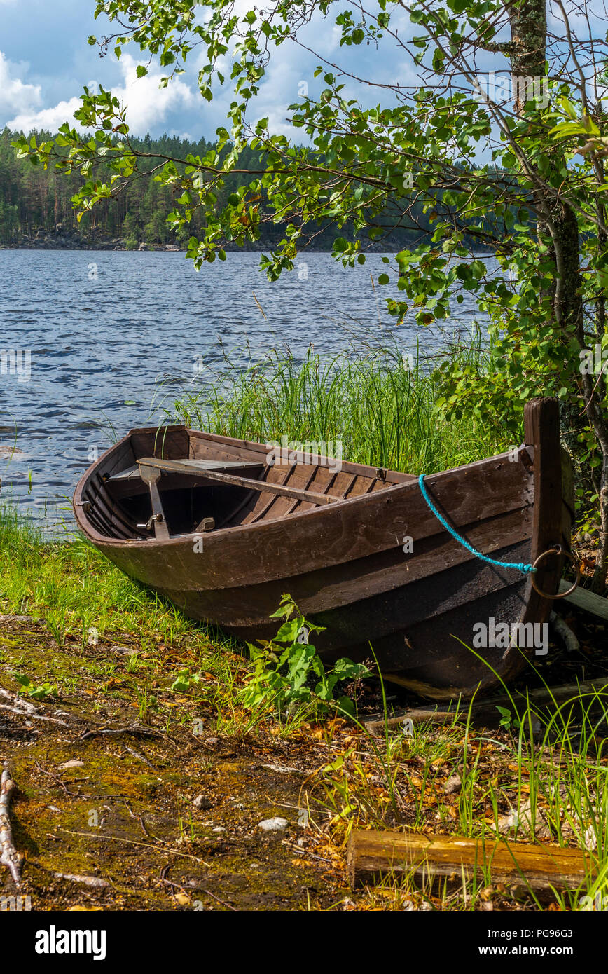 Old wooden rowing boat on the shore of the Saimaa lake in Finland - 3 ...