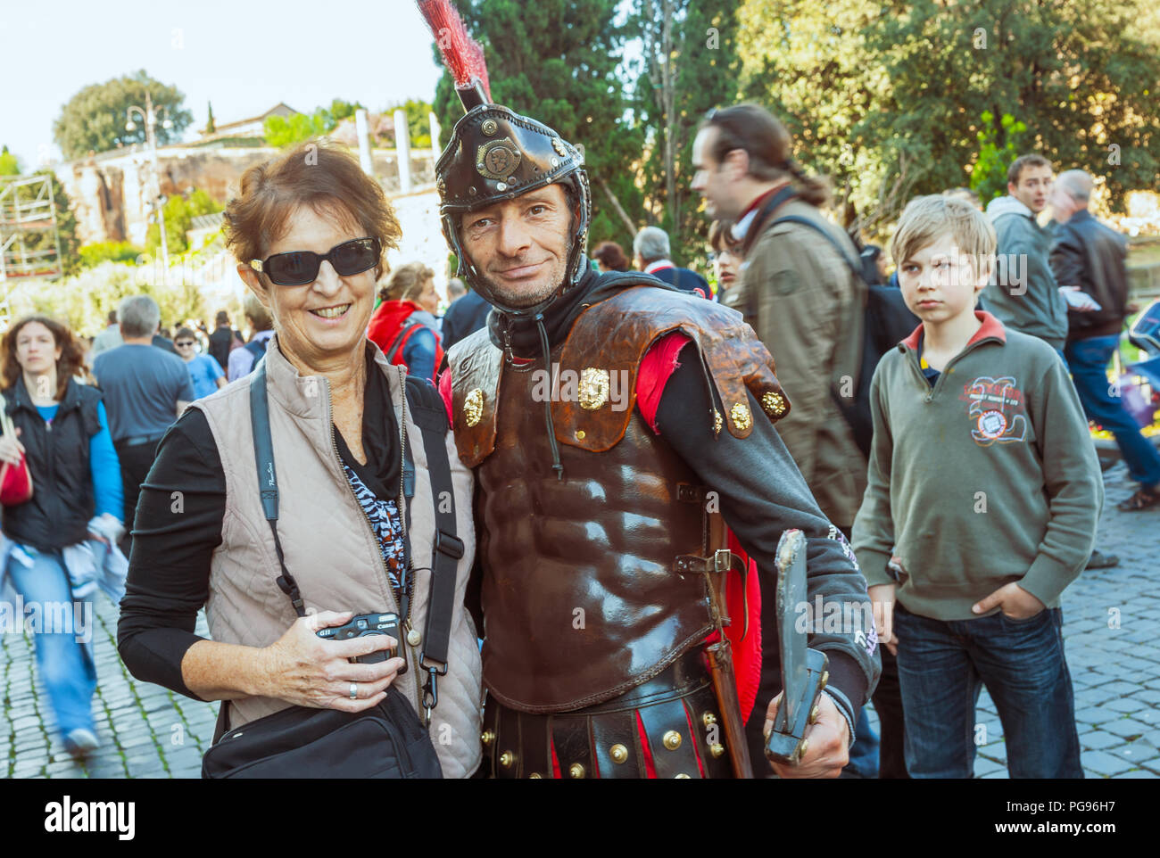 ROME ITALY - APRIL 16 2011; Tourists mingle outside the Coliseum while ...