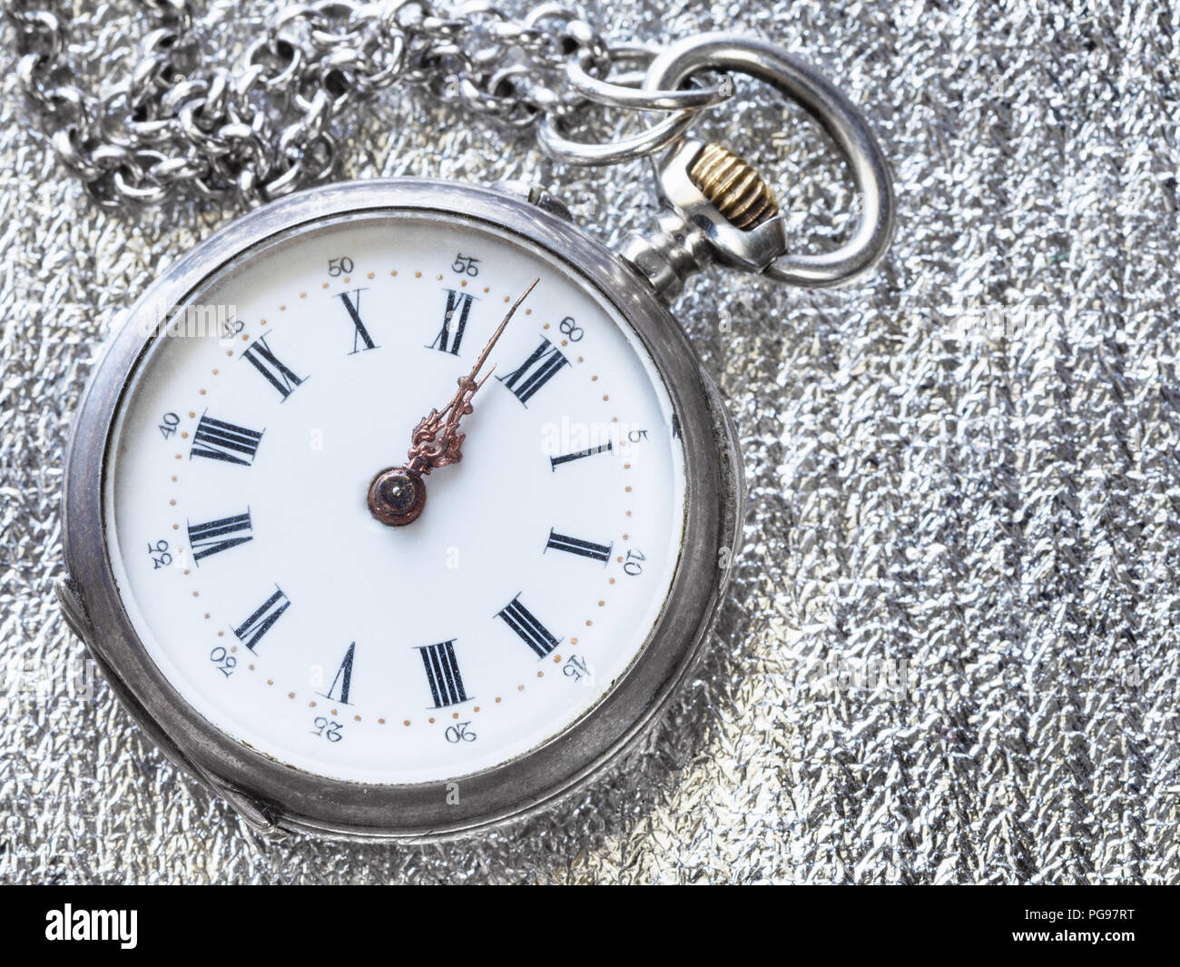 old pocket watch on silver cloth background close up Stock Photo - Alamy