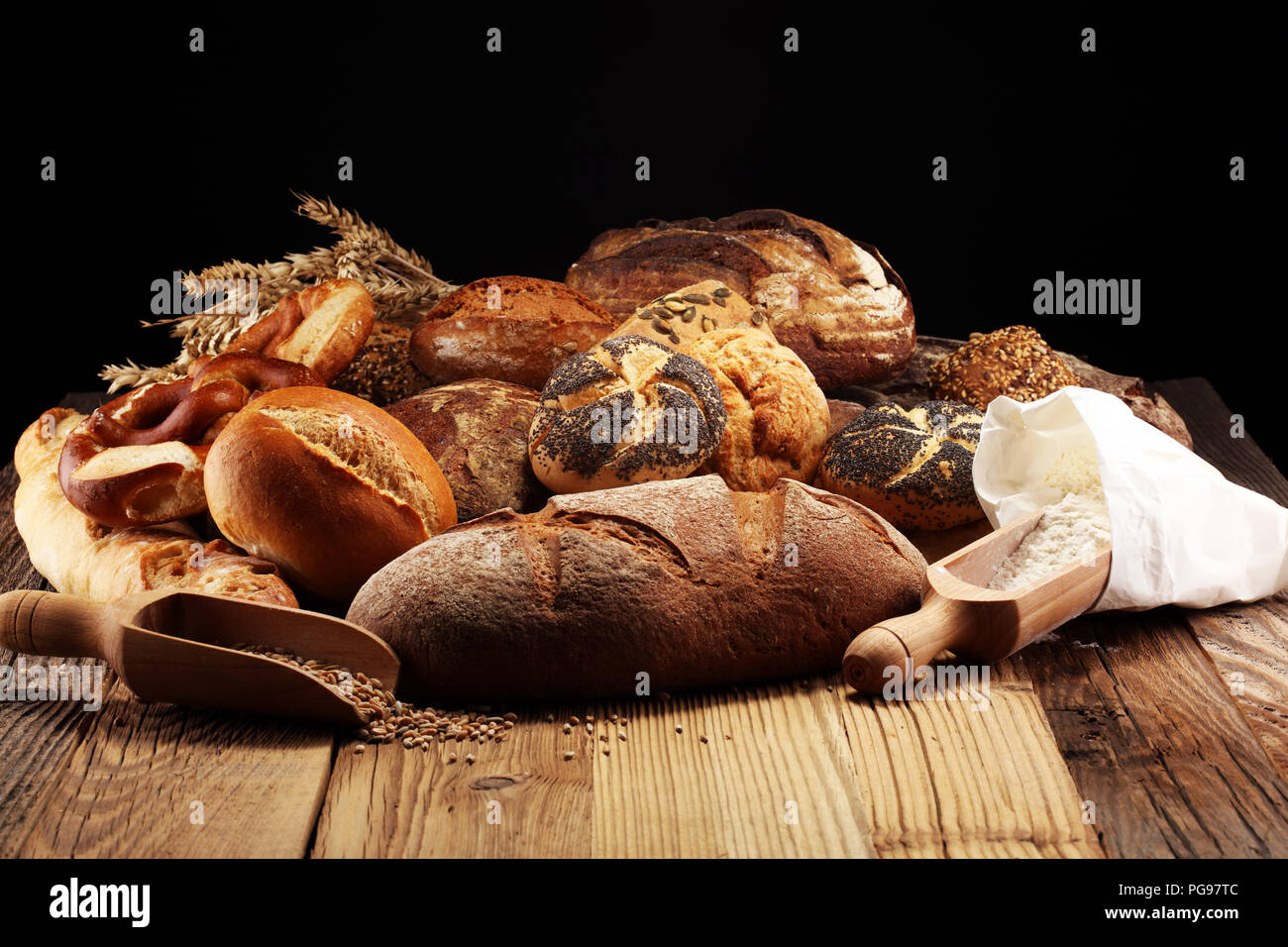 Different kinds of bread and bread rolls on board from above. Kitchen ...