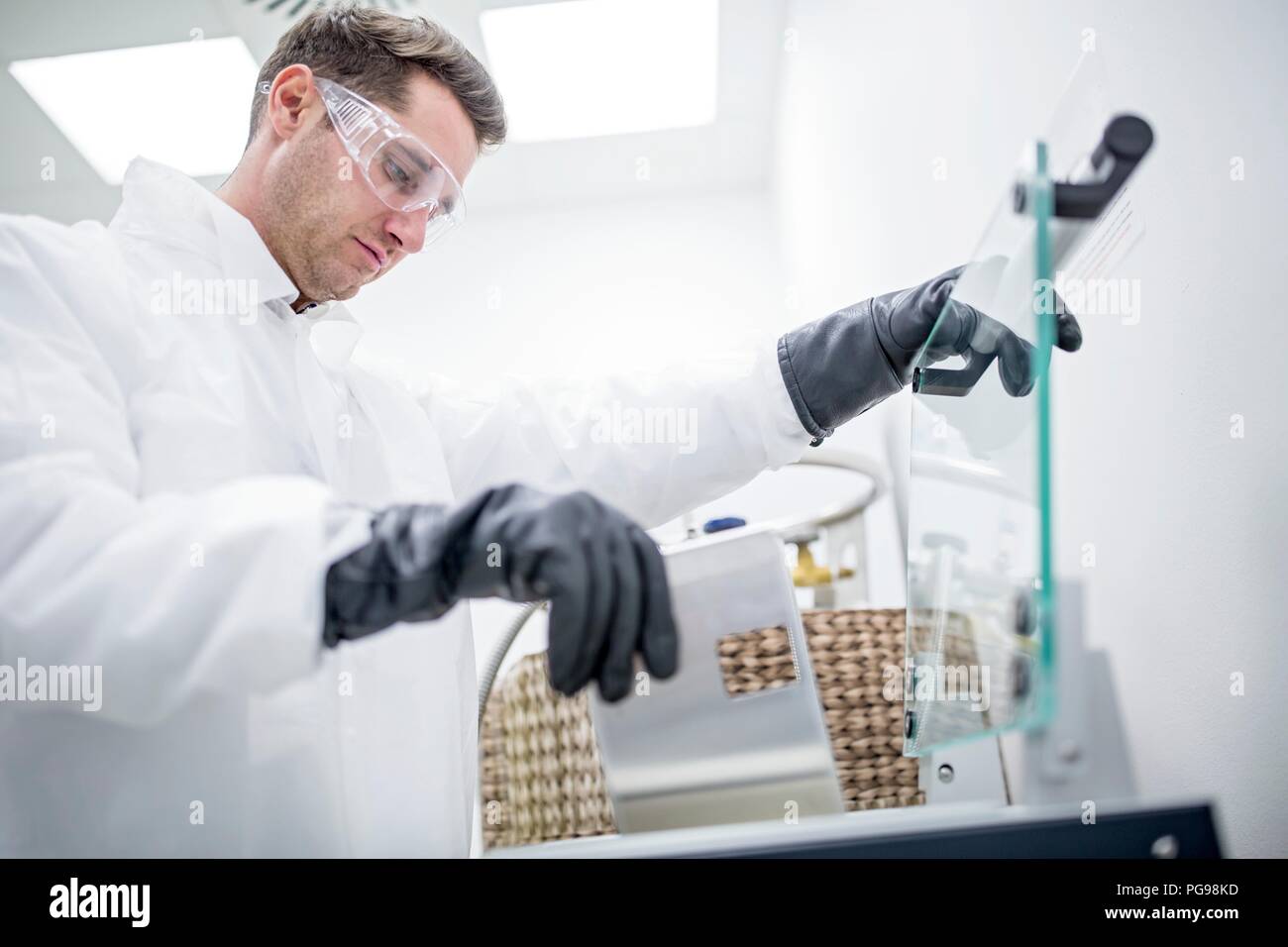 Technician storing stem cell samples in cryostorage. They have been ...