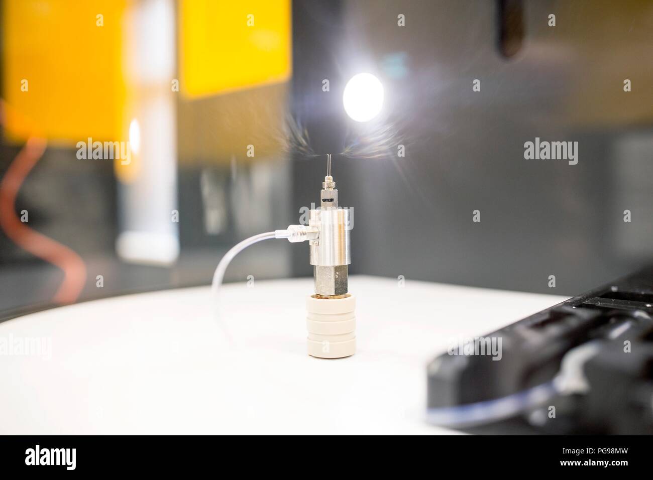 Close-up of an electrospinning machine in a nanofibre laboratory. This ...