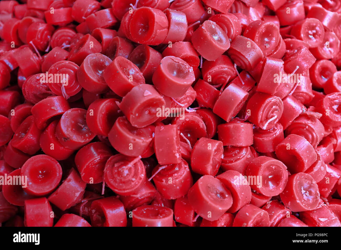 Pile of red votive candles stacked in the Dagkotanan-space aside the ...