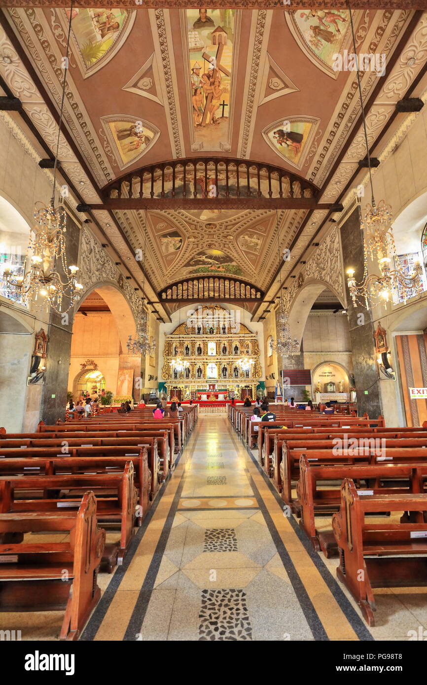 Nave of the church with devotees at pray-ceiling paintings of biblical ...