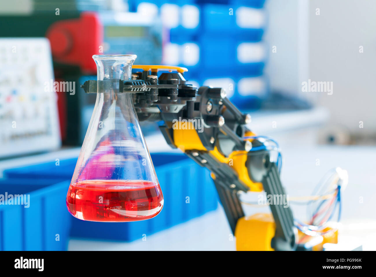 Robotic arm holding flask Stock Photo - Alamy
