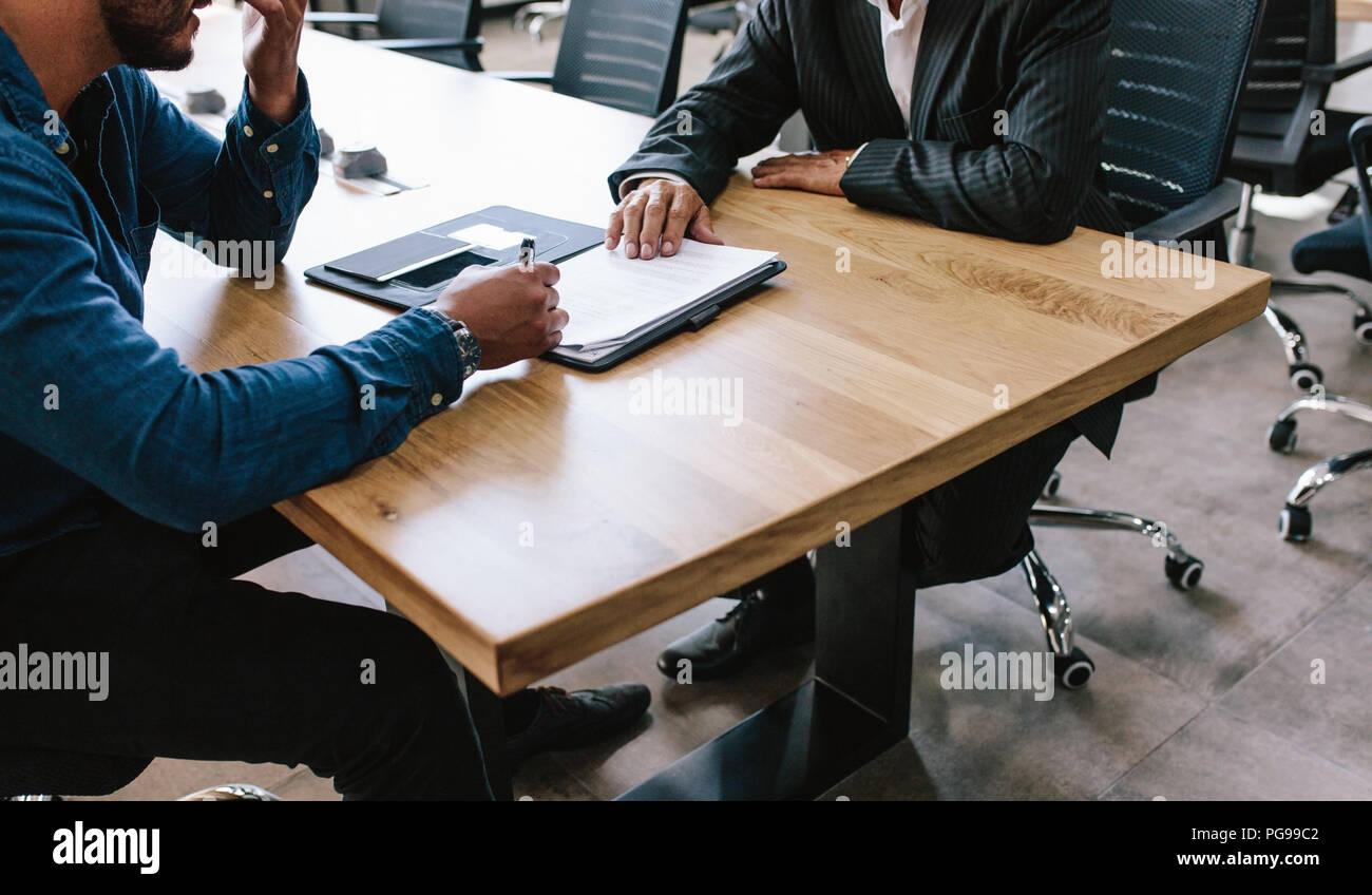 Two people signing business contract hi-res stock photography and ...