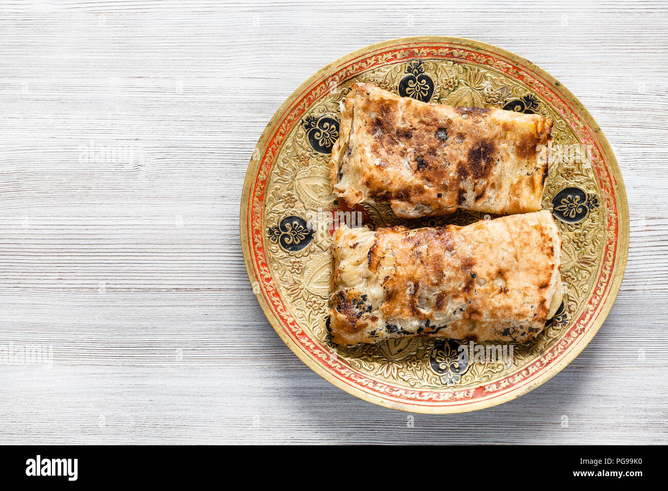 Indian cuisine - rolled Butter Naan flat bread baked in tandoor with ...