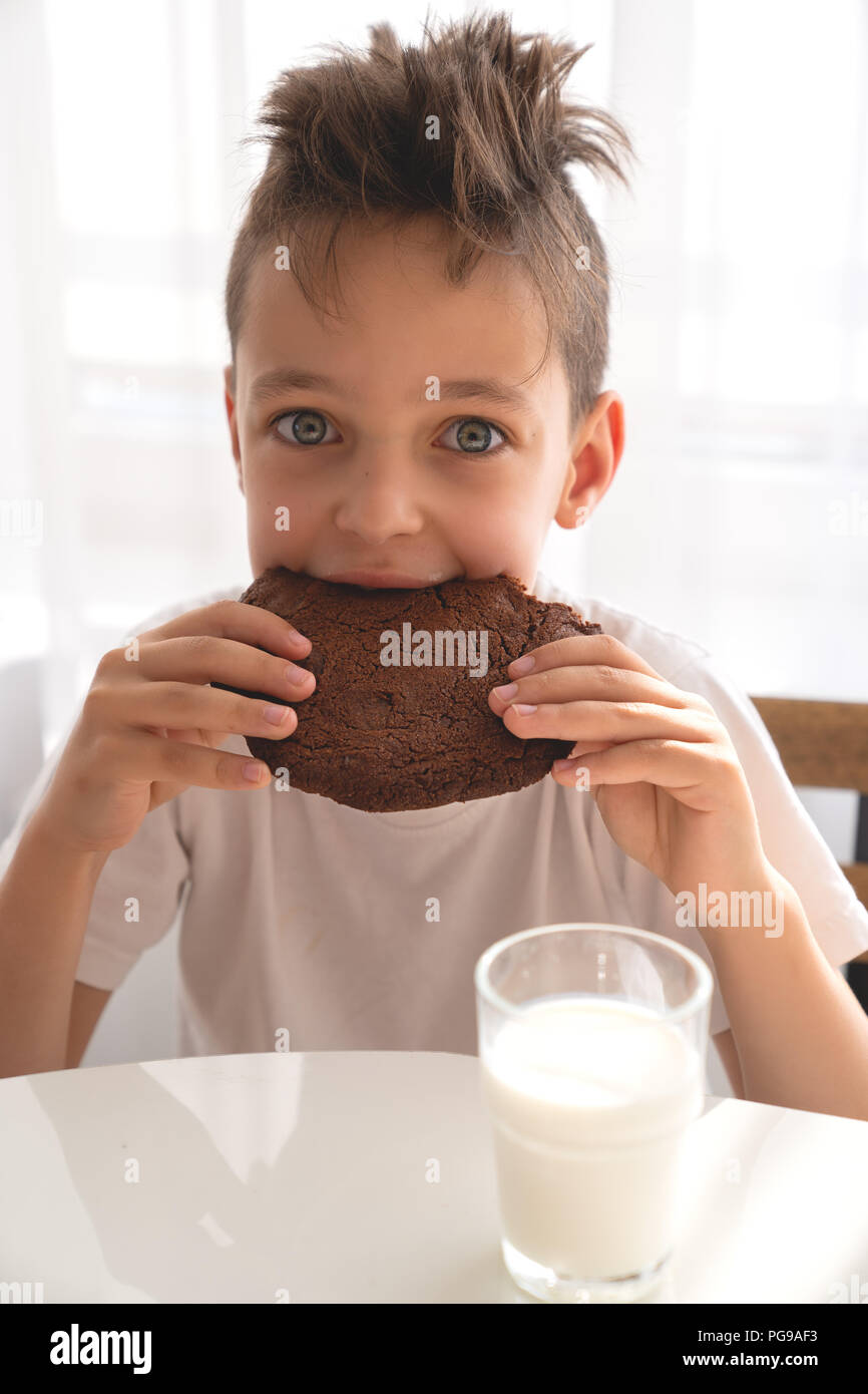 Teenager boy eating cookies hi-res stock photography and images - Alamy