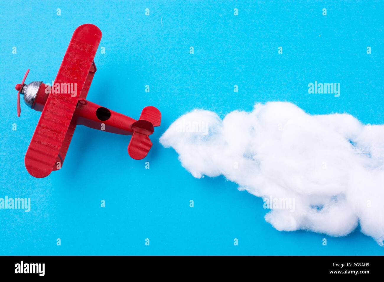 Retro styled little red model airplane in sky Stock Photo - Alamy