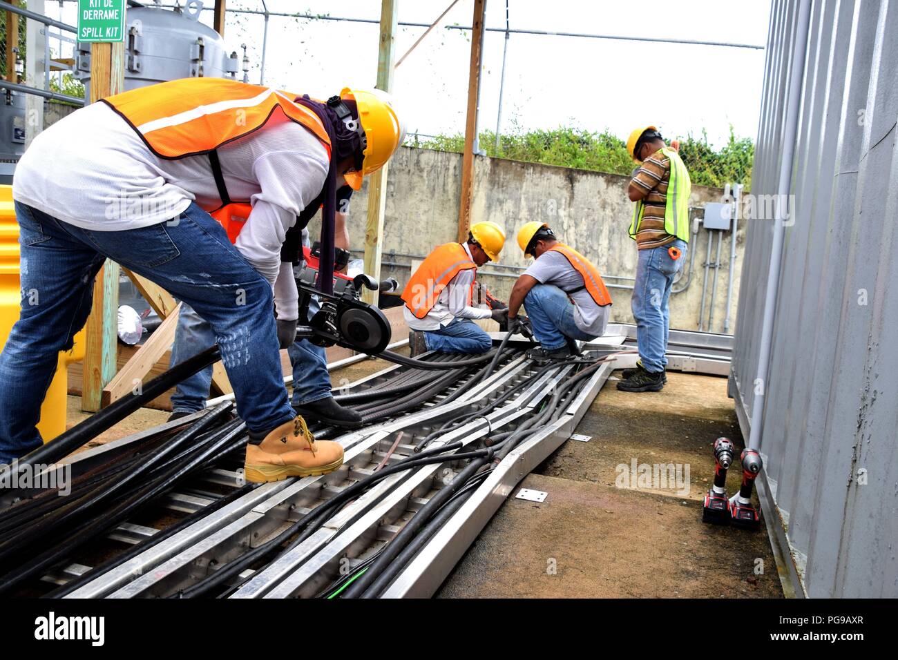 Construction crew removes power lines as part of the demobilization of ...